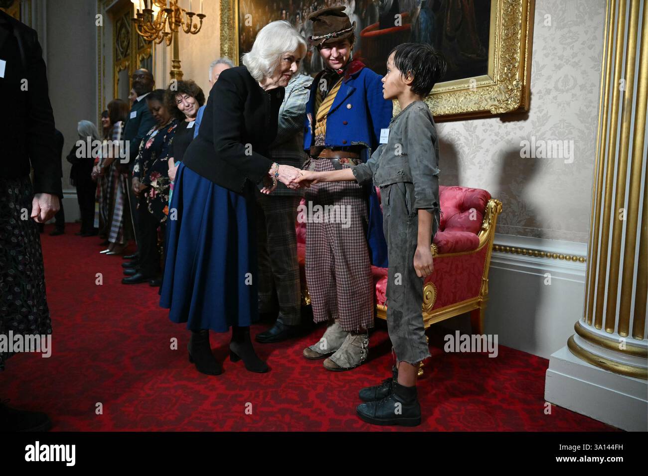 Queen Camilla meets with cast from Oliver, Billy Jenkins (second right) and Raphael Korniets ...