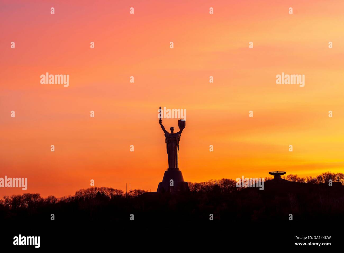 Mother Ukraine statue in front of beautiful evening sky in Kyiv. The ...