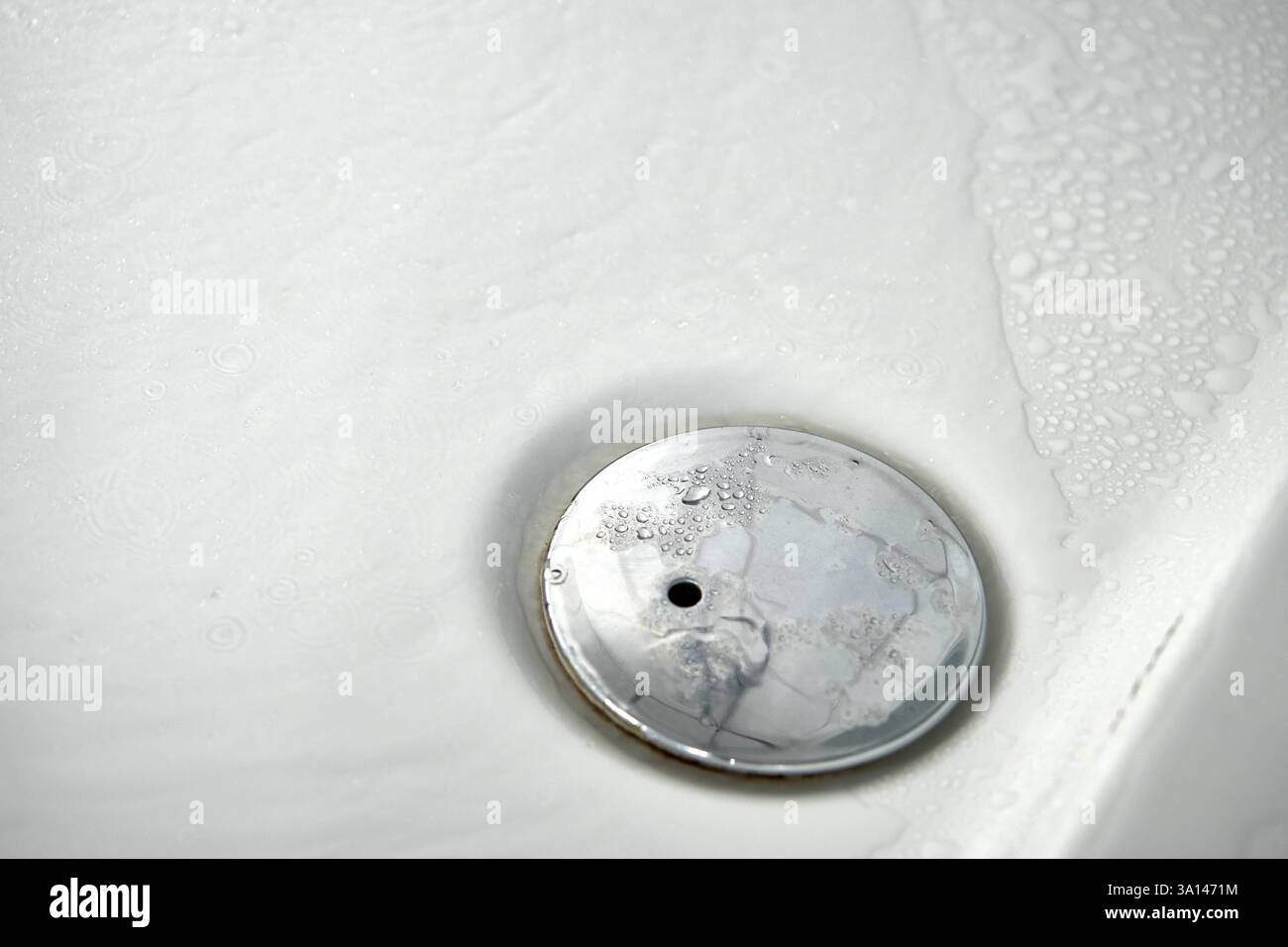 Germany - March 4, 2025: A wet drain in a shower with water droplets on ...