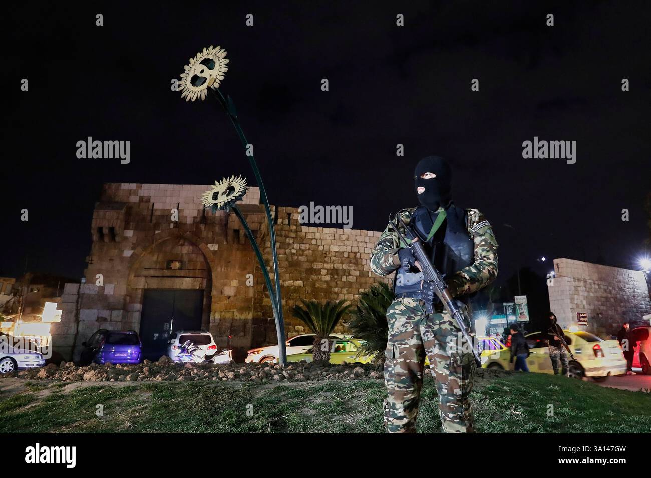 A member of the Syrian government security forces stands guard at a ...