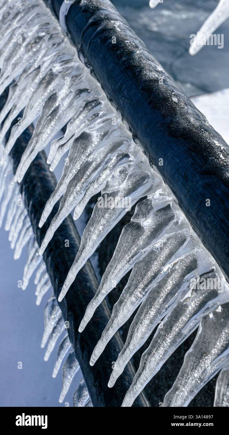 Beautiful Icicles Forming on a Metal Fence with Sunlight Creating a ...