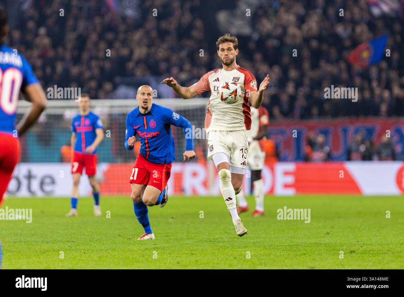 Tanner Tessmann of Lyon being chased by Vlad Chiriches of FCSB during ...