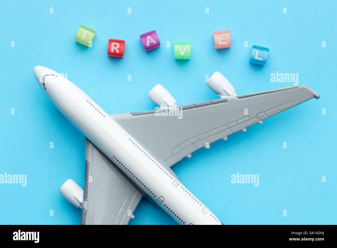 Travel concept. Plane model and colorful cubes on light blue background ...