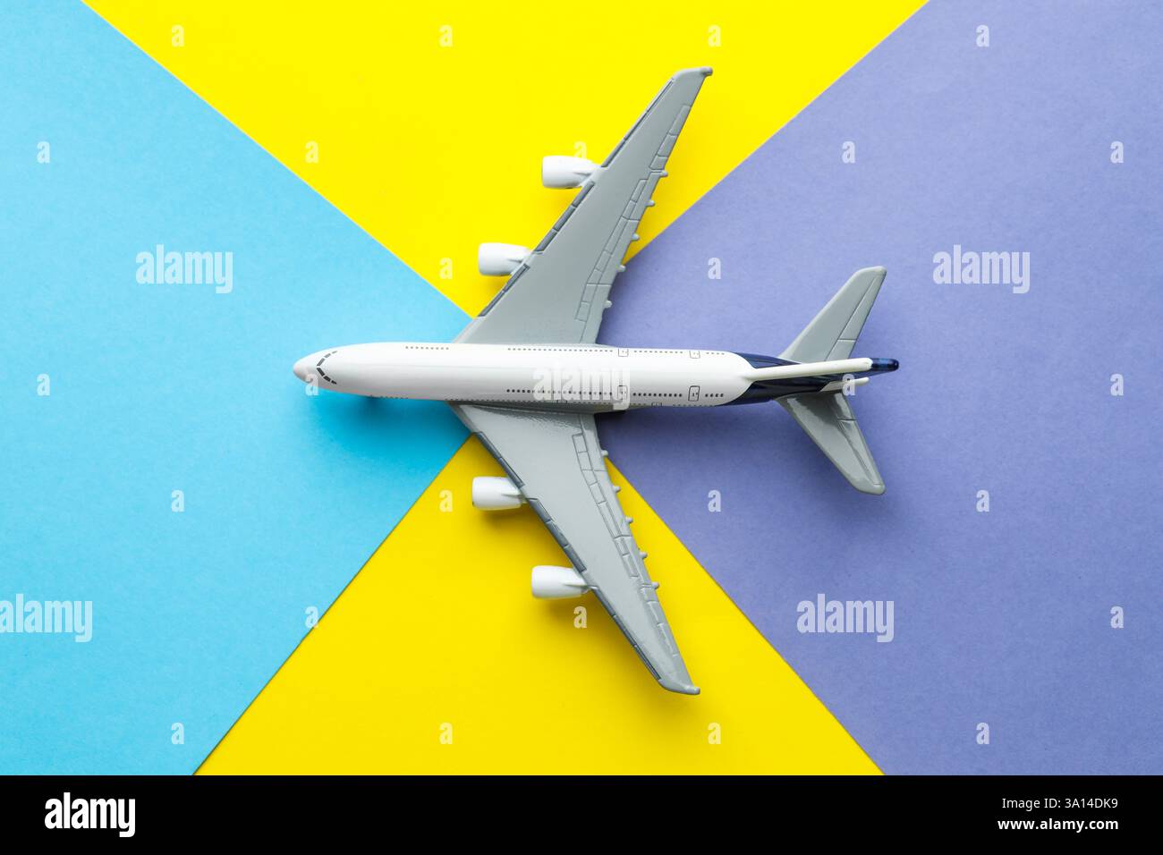 Plane model flying on color background, top view Stock Photo - Alamy