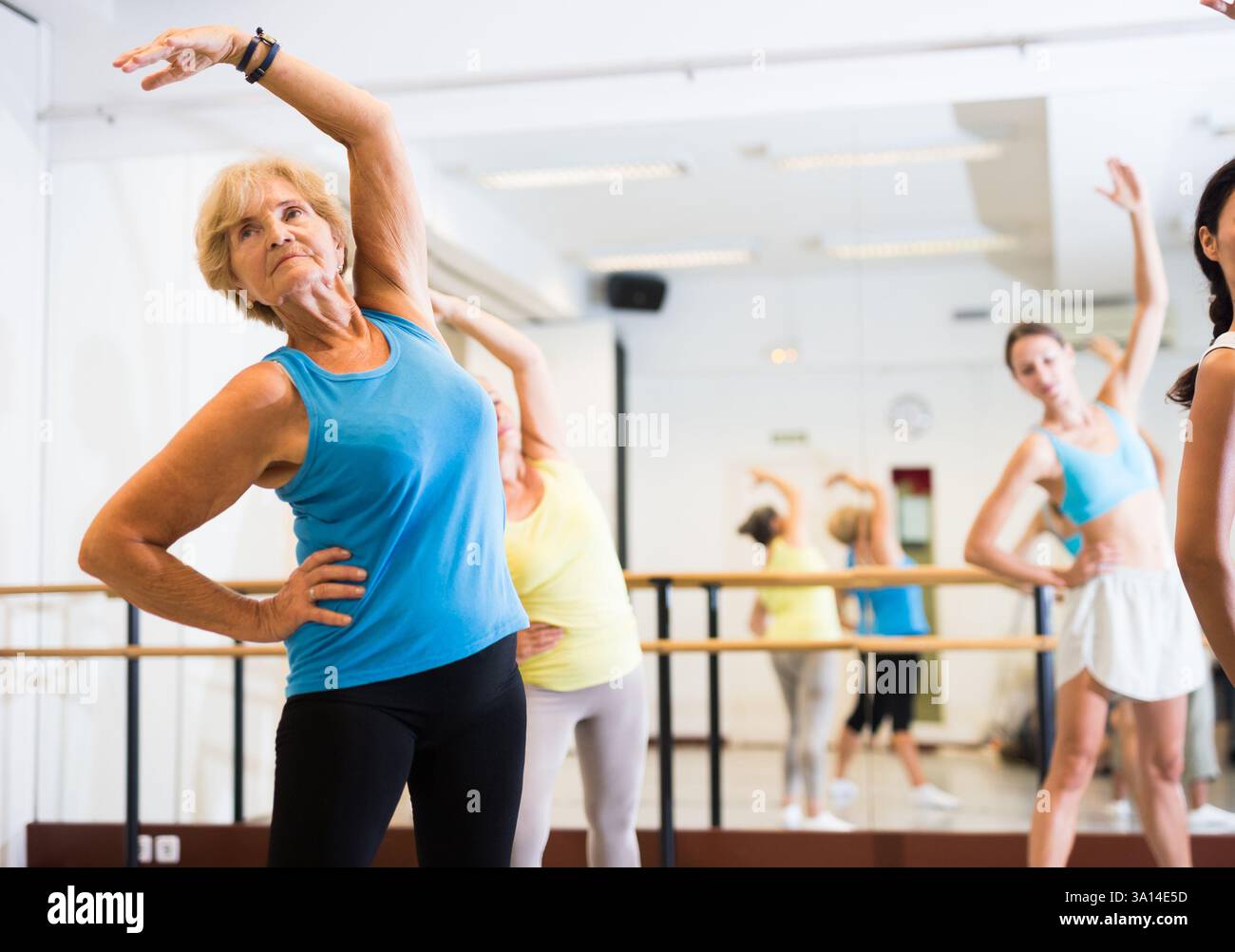 Old lady dancing with group in studio Stock Photo - Alamy