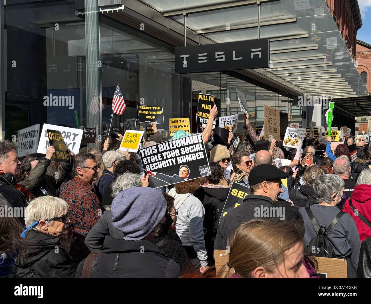 Protestors outside a Tesla Dealer in New York City expressing their ...