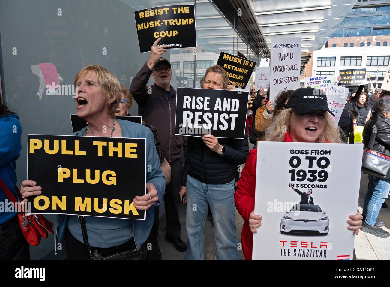 Protestors outside a Tesla Dealer in New York City expressing their ...