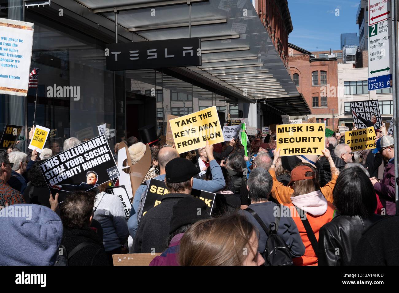 Protestors outside a Tesla Dealer in New York City expressing their ...