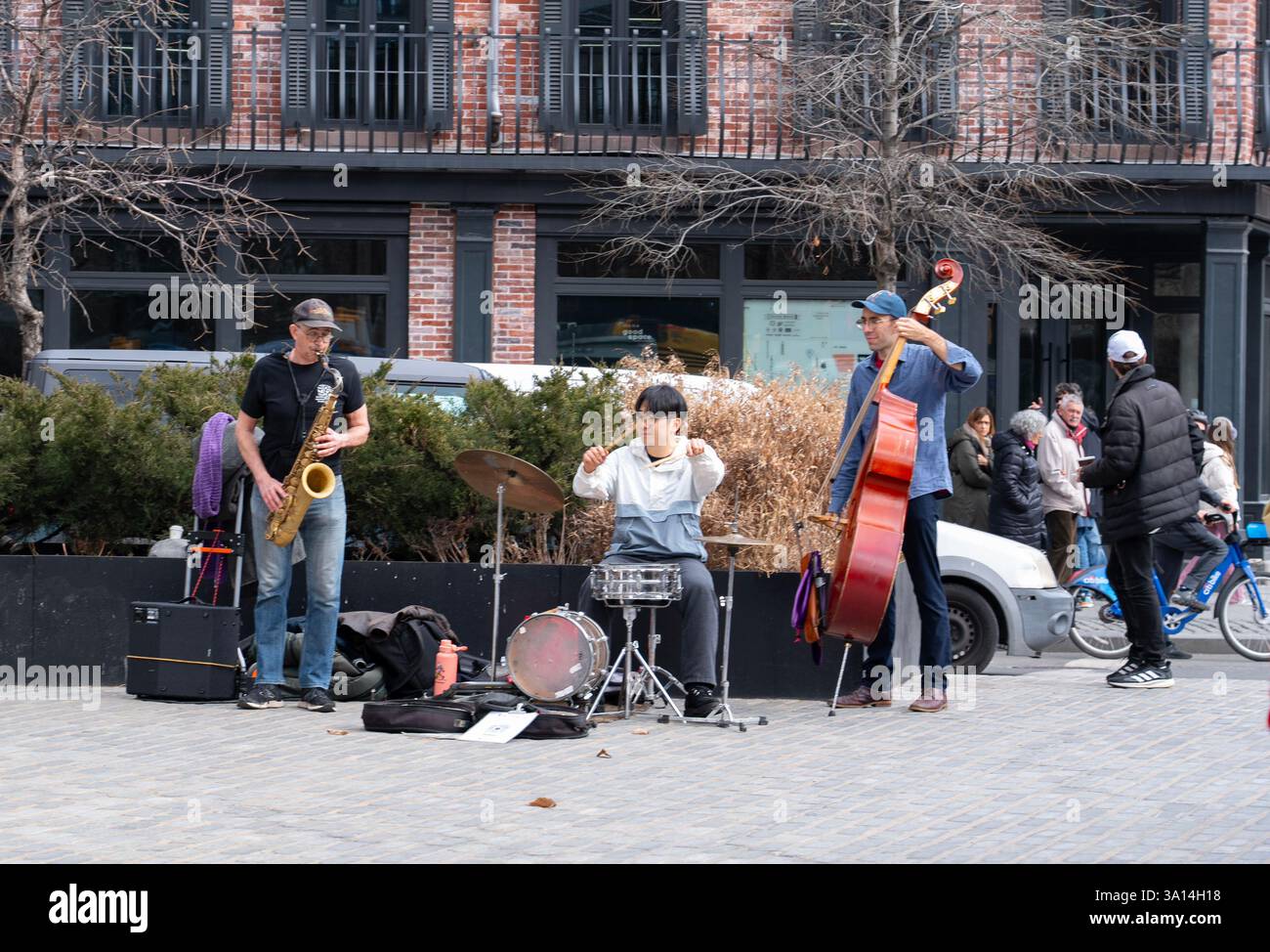 Jazz trio performs on the street in the Chelsea neighborhood, of ...
