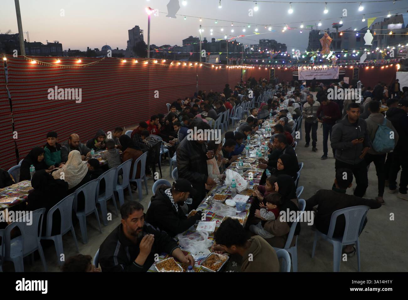 Gaza. 6th Mar, 2025. People gather for a group Ramadan iftar amid ...
