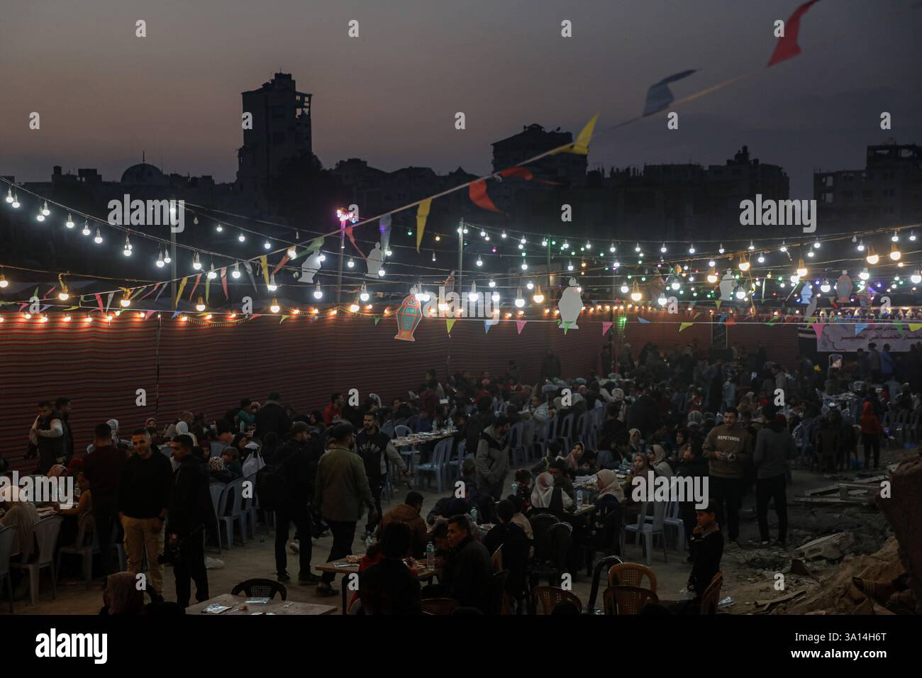 Gaza. 6th Mar, 2025. People gather for a group Ramadan iftar amid ...