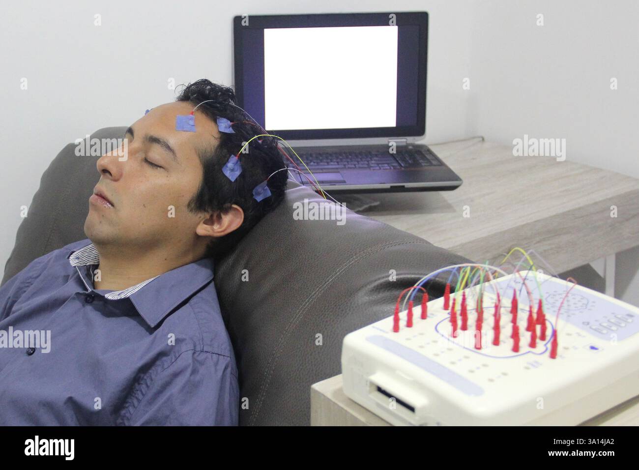 Electroencephalogram EEG in adult Latino man with wires in his head ...