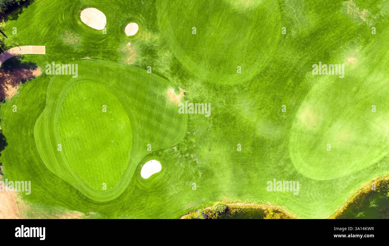 Aerial view of a golf course putting green with sand bunkers and hole ...