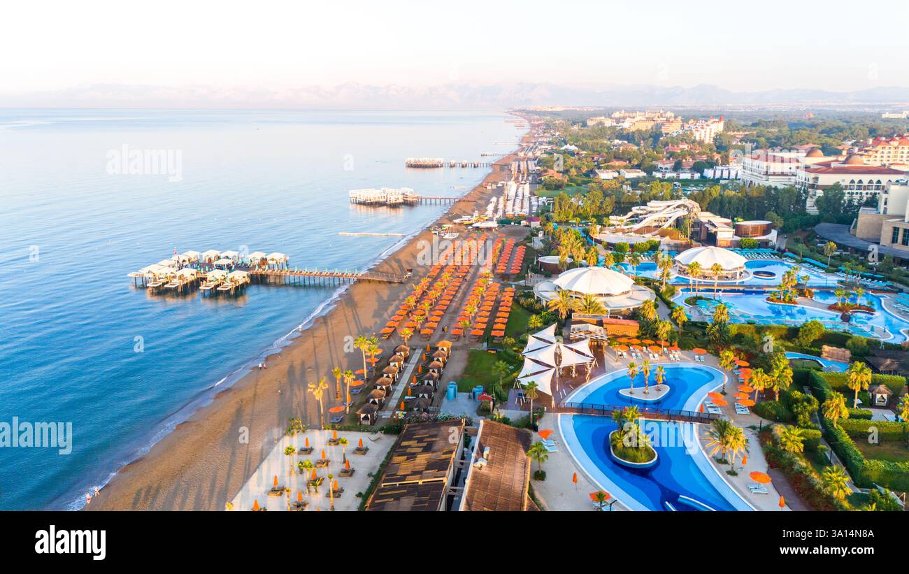 Aerial view of a beachfront luxury resort with pools, a water park, and ...