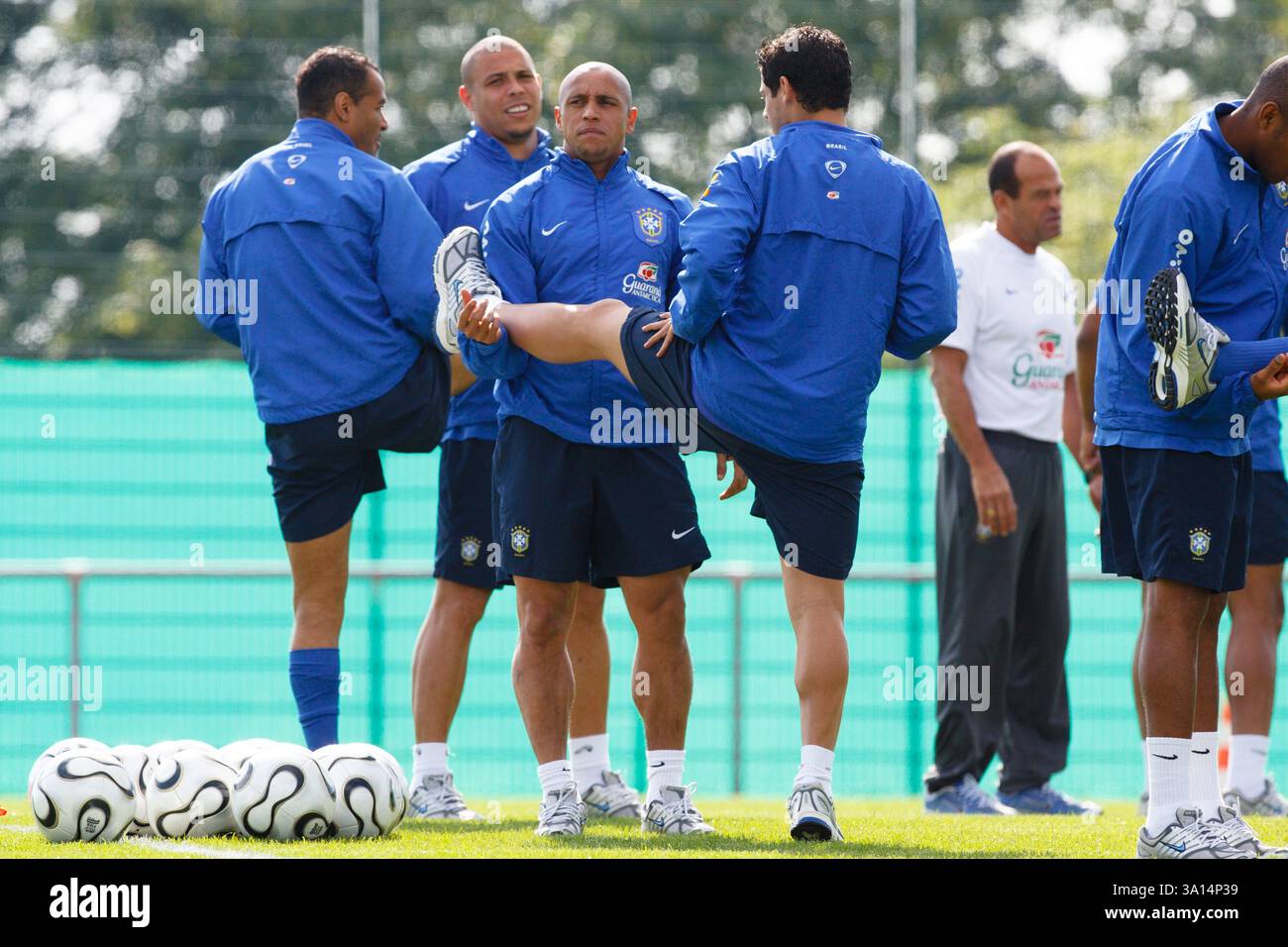 Roberto Carlos of Brazil (C) holds a teammates leg as the Brazilian ...