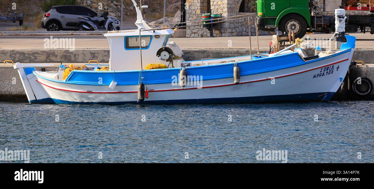 Traditional working fishing boat moored at Livadia harbour, Tilos ...