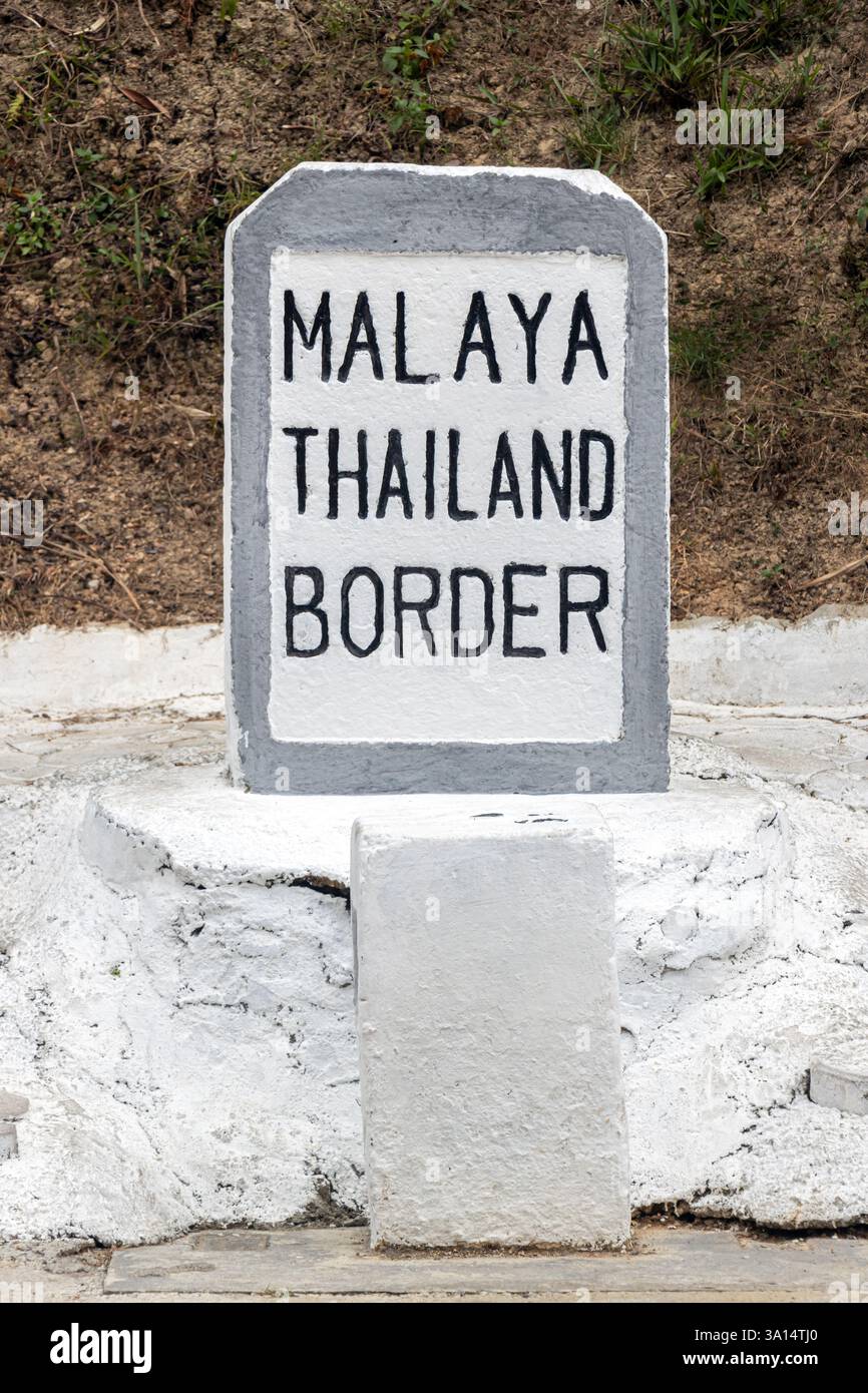 Stone milestone at the border crossing between Malaysia and Thailand ...
