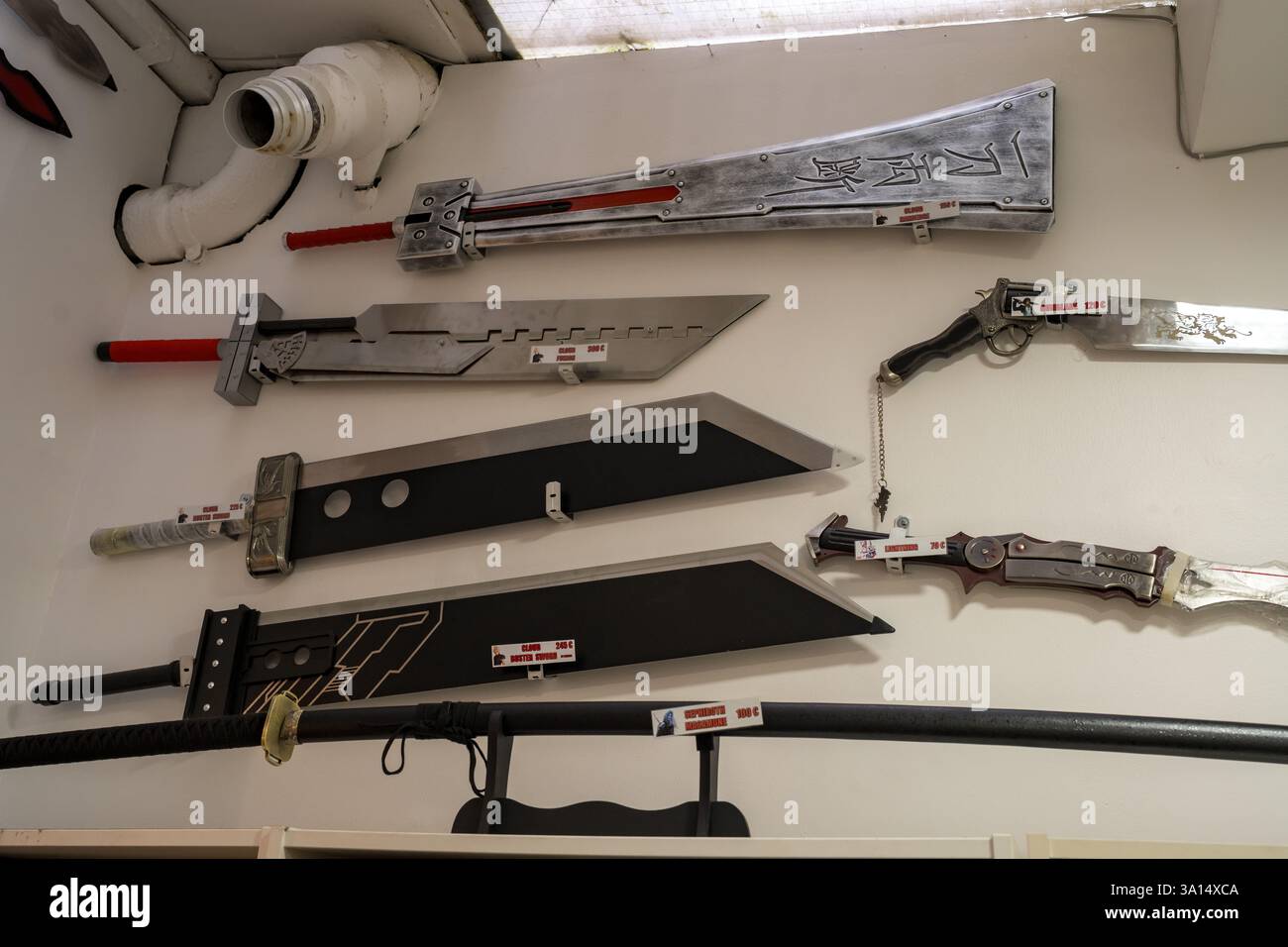 Unique collection of decorative swords mounted on display in an artisan ...