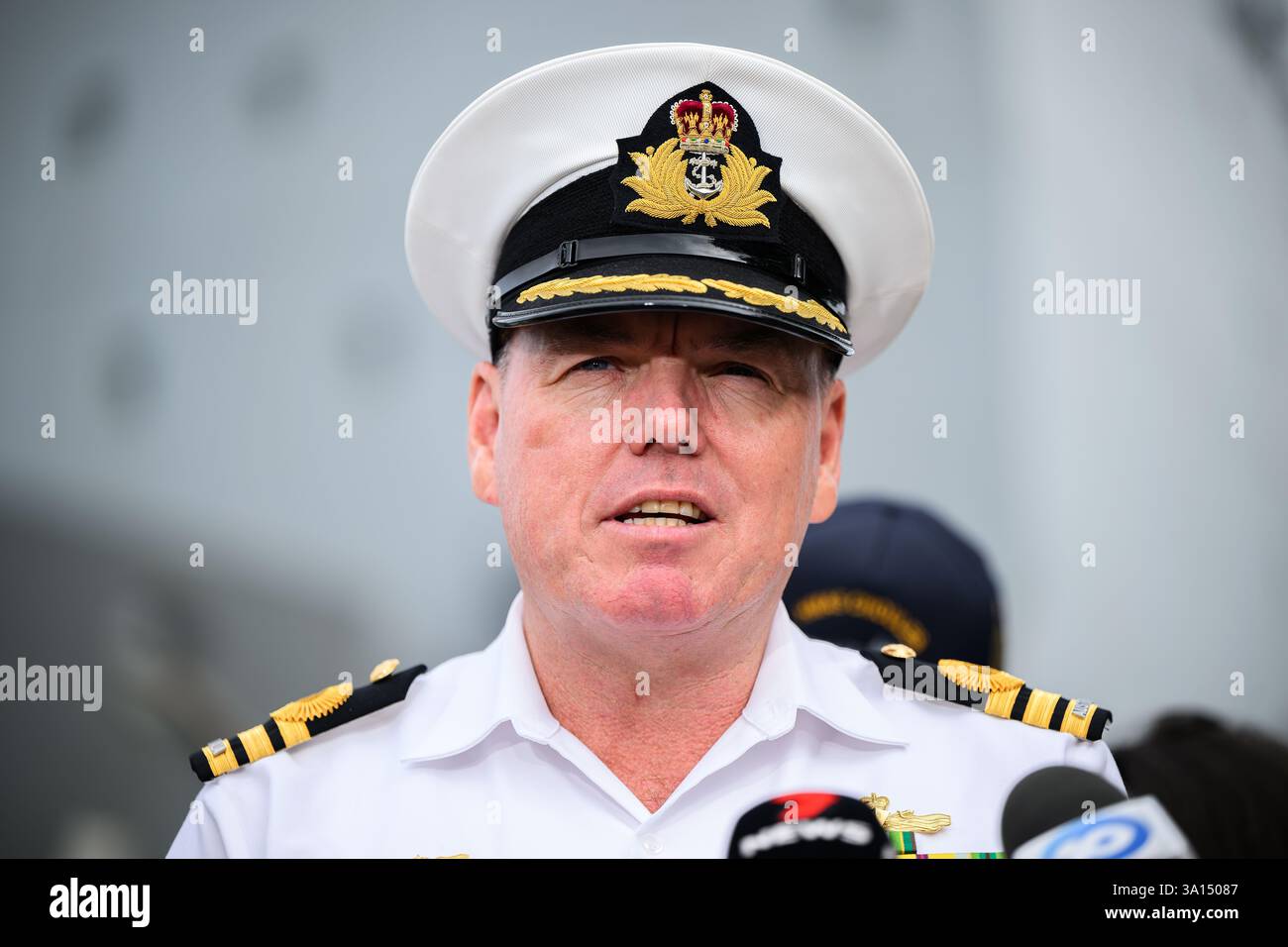 Commanding Officer of HMAS Choules Commander Arron Convery speaks to ...