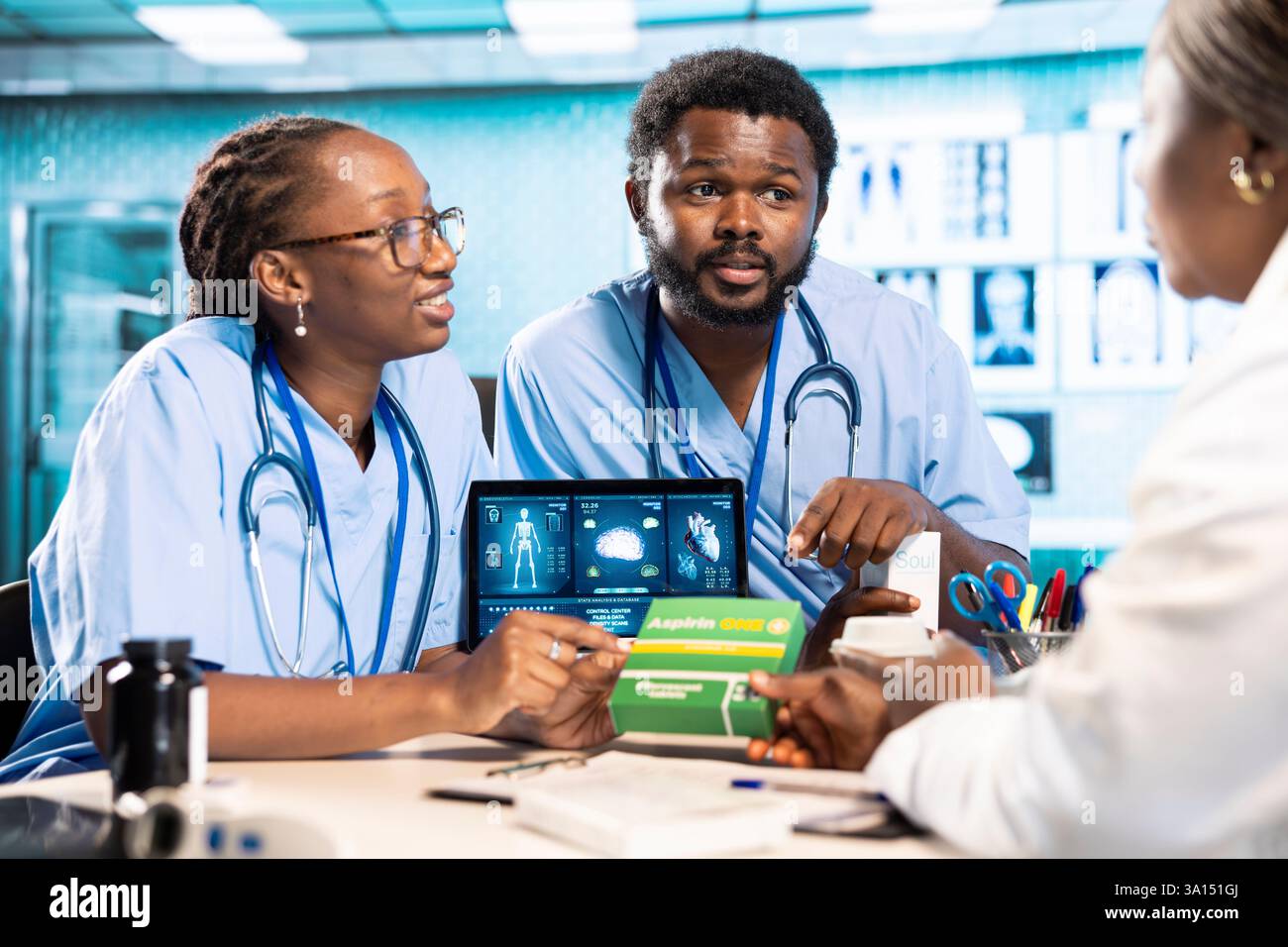 Male and female young nurses in scrubs engaged in professional training ...