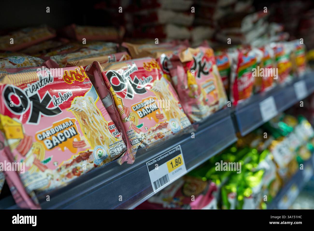 Colorful variety of instant noodles displayed on supermarket shelves ...