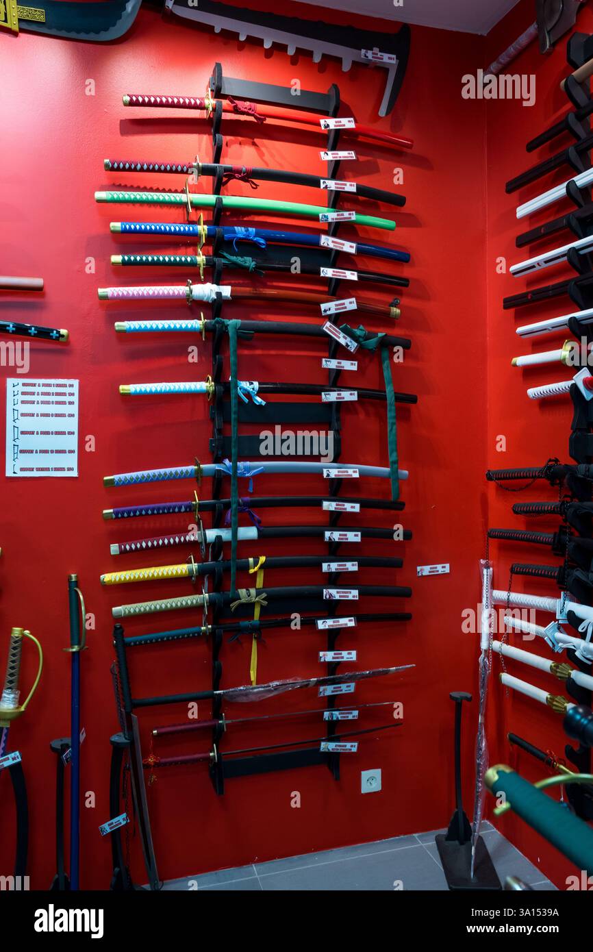 Colorful collection of decorative swords displayed on a vibrant red ...