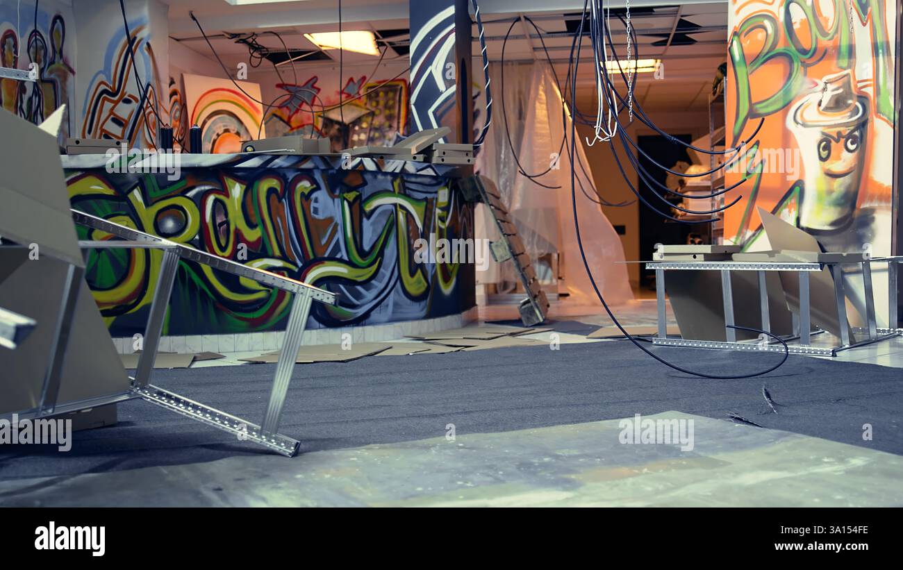 Trucking right shot of abandoned basement with graffiti drawings on ...