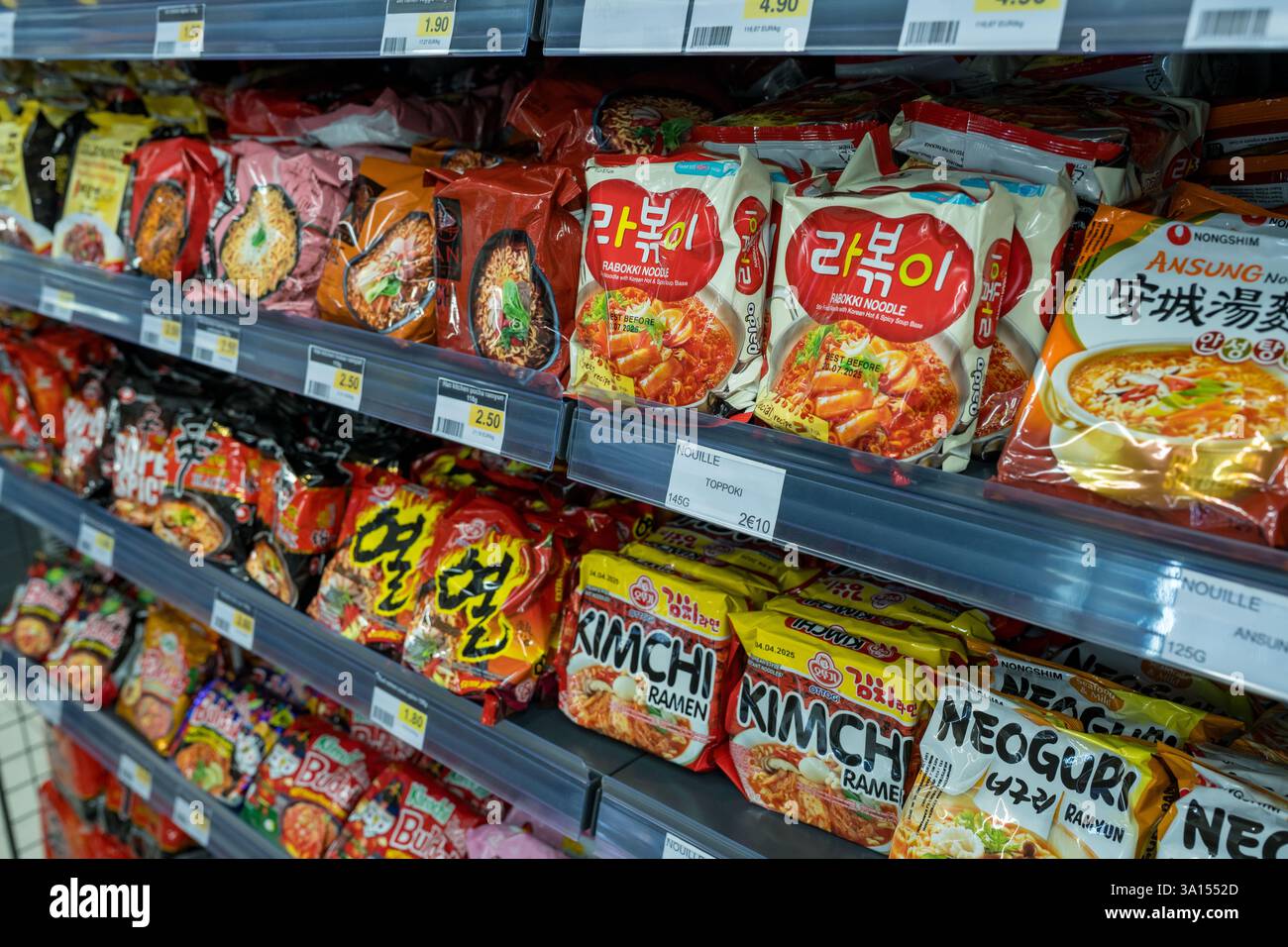 Brightly colored instant noodle packages arranged neatly on display in ...