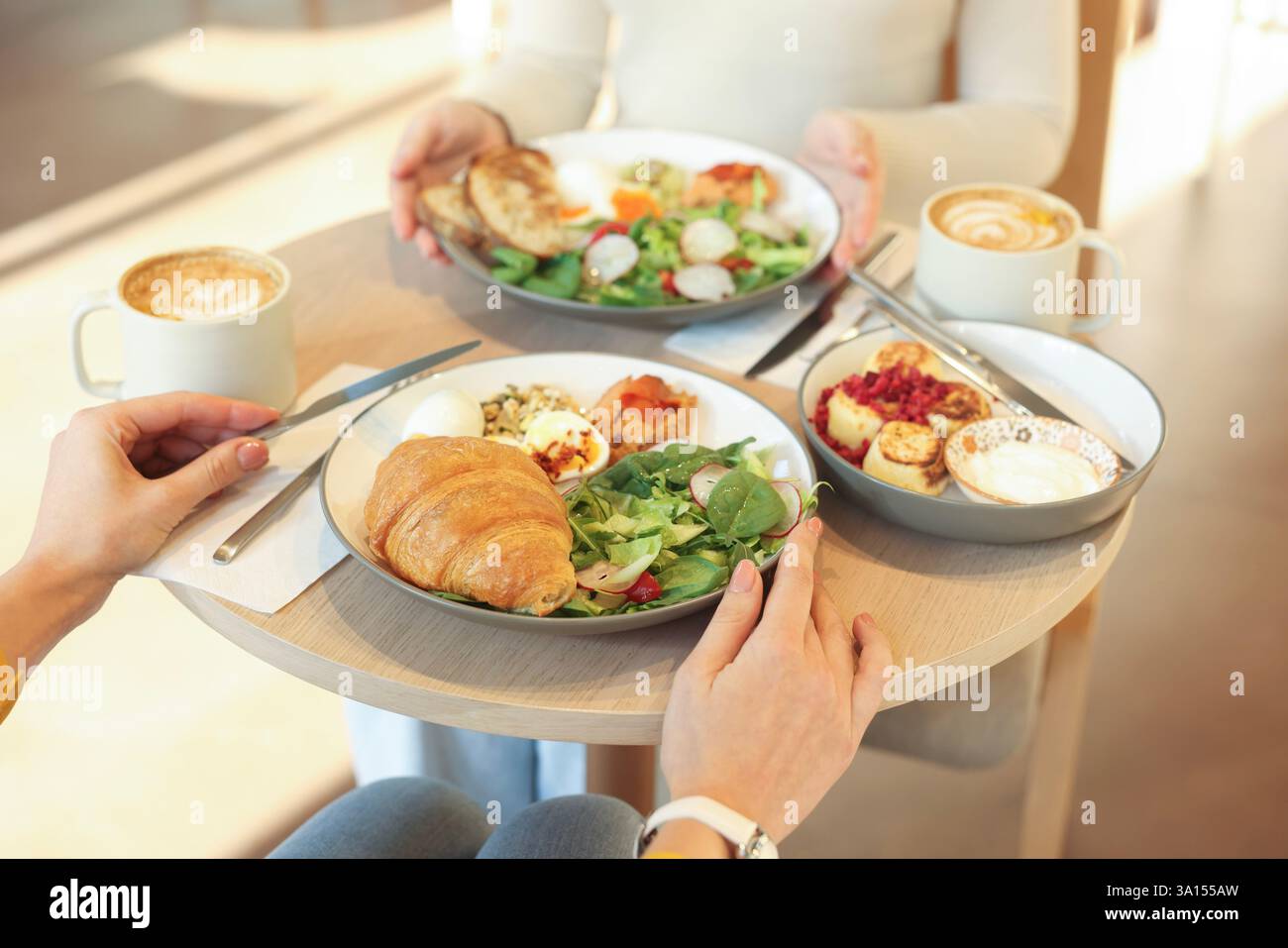 Women having tasty breakfast in cafe, closeup Stock Photo - Alamy