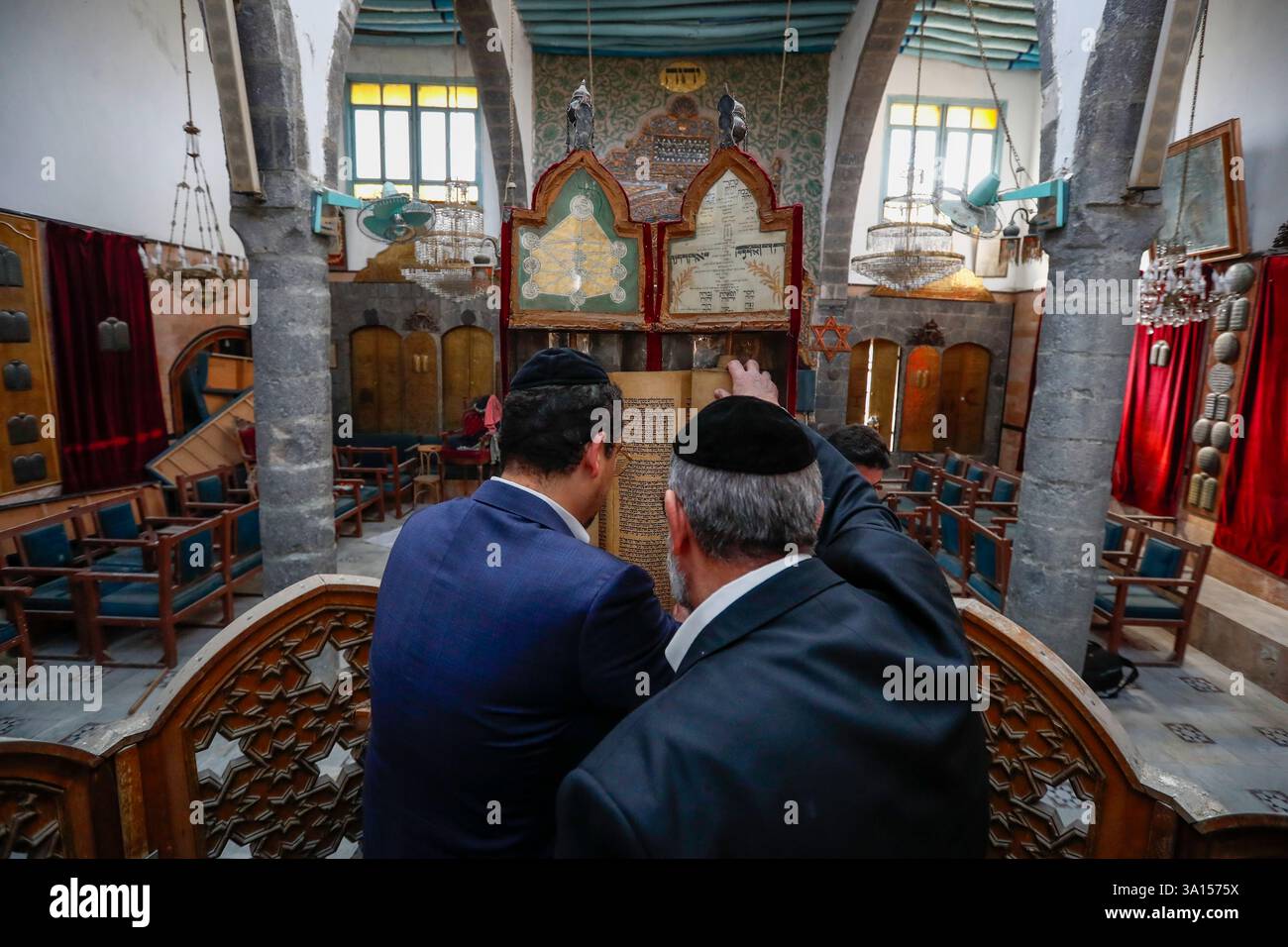 FILE - Rabbi Yusuf Hamra, right, and his son Henry lookout an old ...