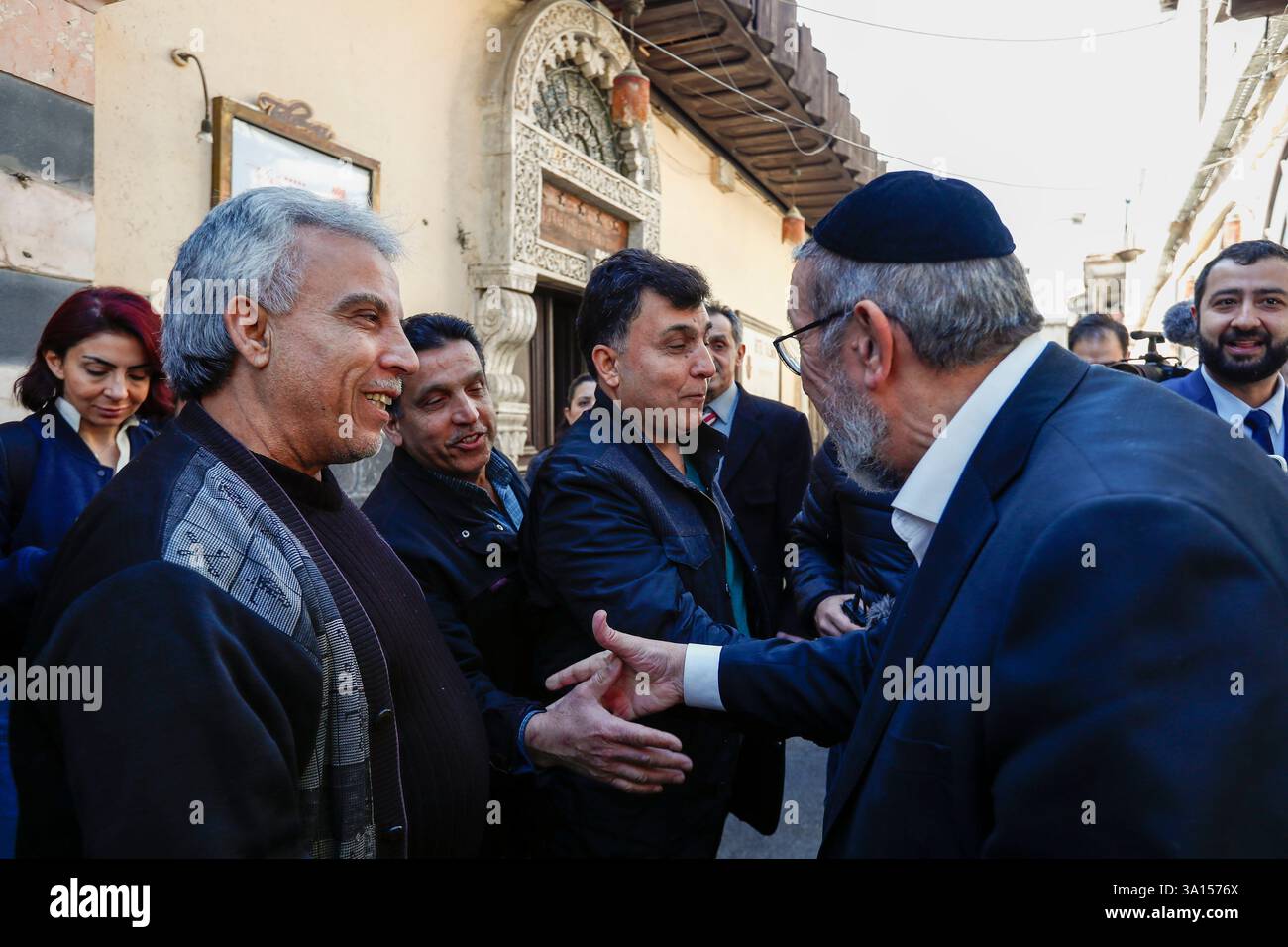 FILE - Rabbi Yusuf Hamra, right, is greeted by neighbours in the old ...