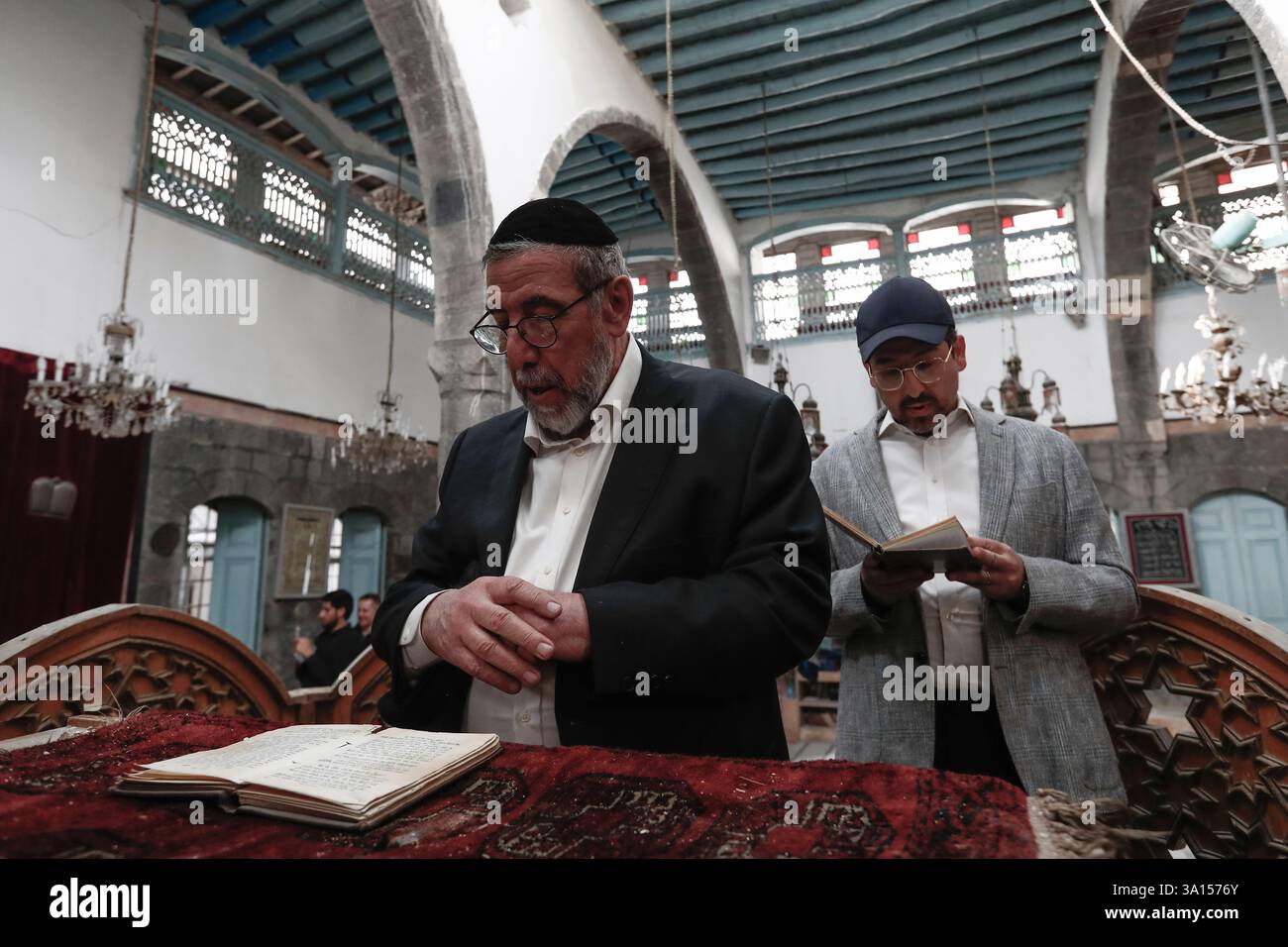 FILE - Rabbi Yusuf Hamra, center left, prays the Al-Raqi synagogue in ...