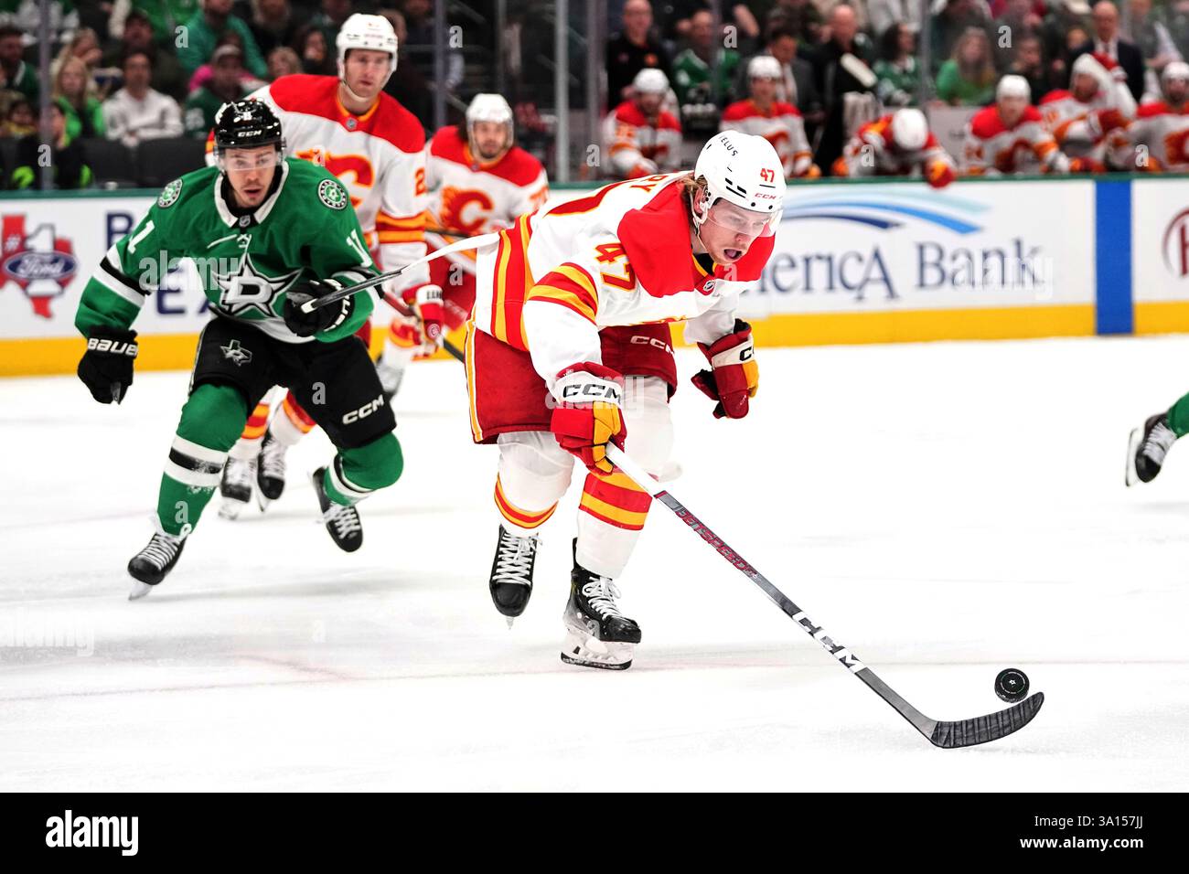 Calgary Flames' Connor Zary (47) reaches out to the puck as Dallas ...