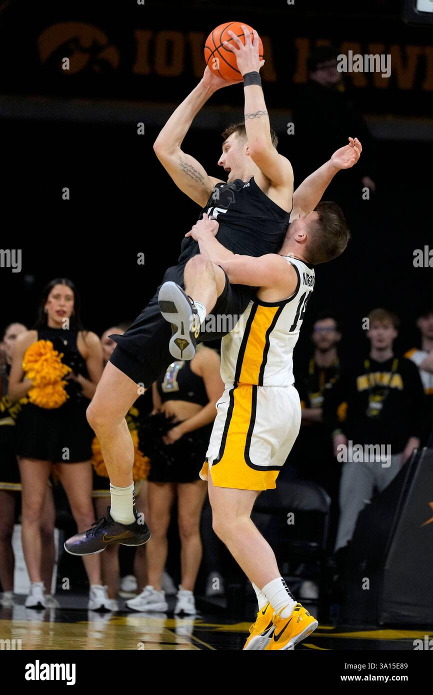 Michigan State center Carson Cooper is fouled by Iowa guard Carter ...