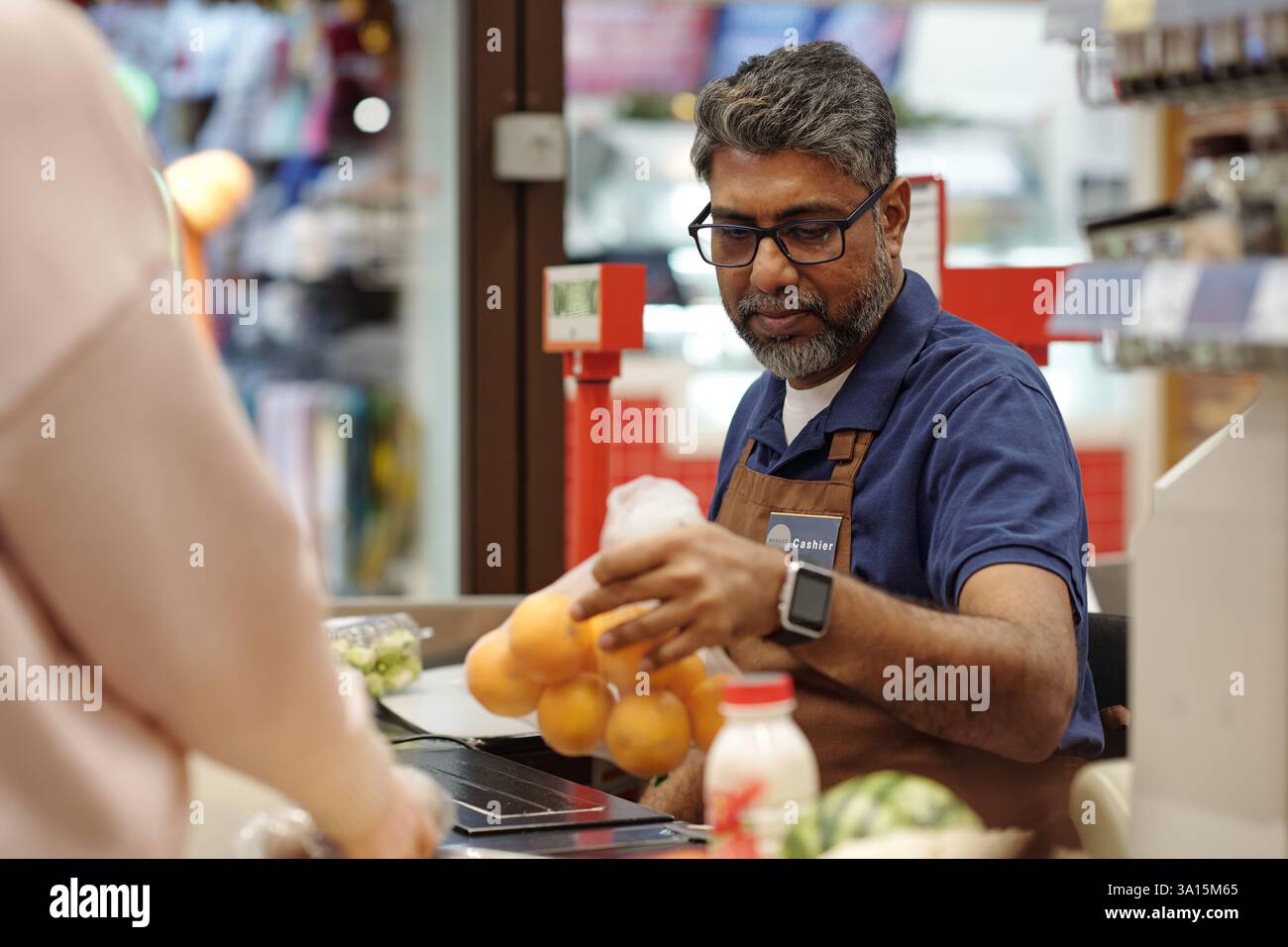 Indian Man as Cashier in Store Stock Photo - Alamy