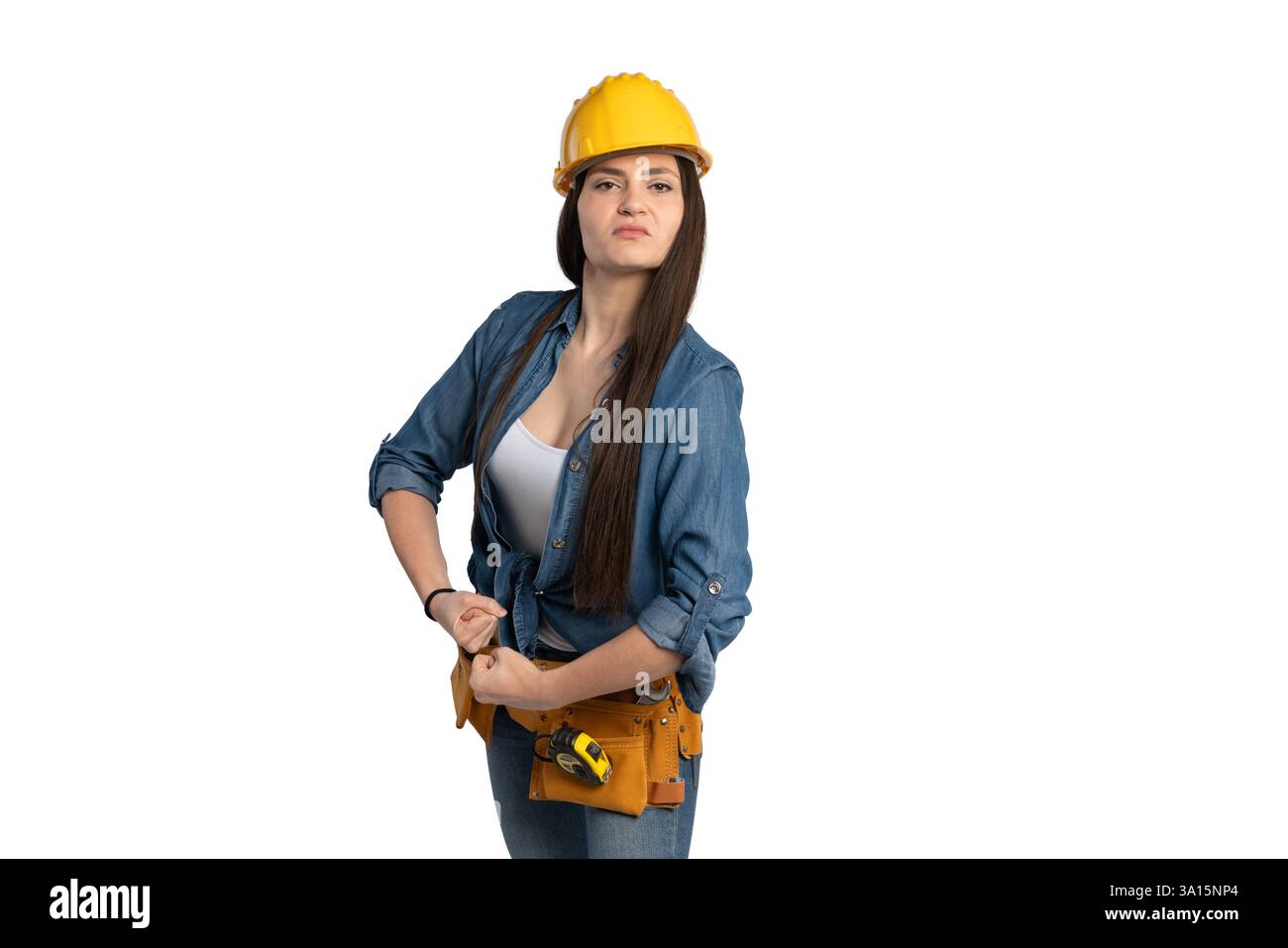 Young female construction worker wearing a yellow hard hat and tool ...