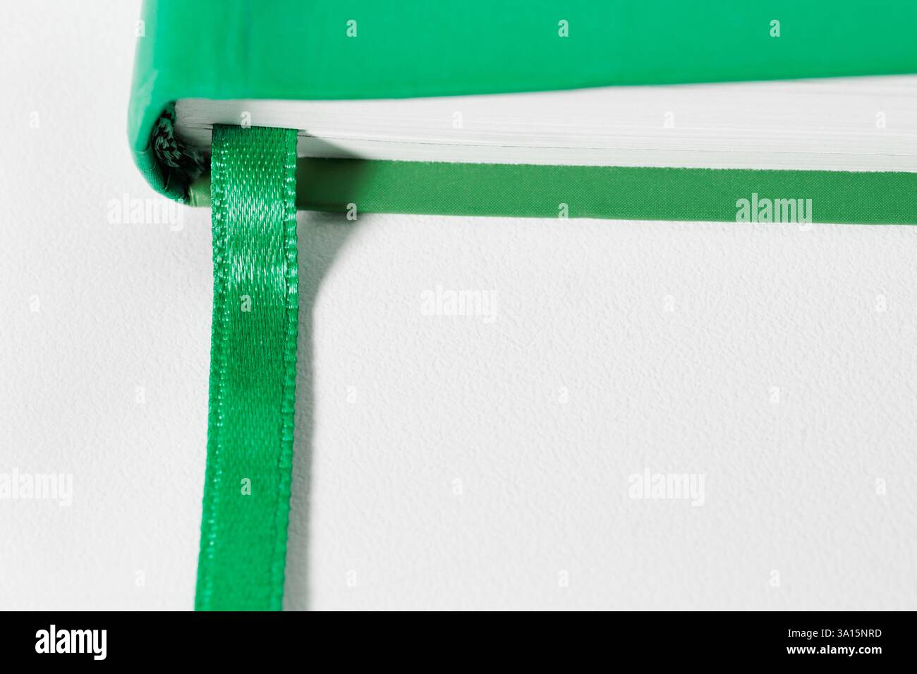 Closed book with green cover and green ribbon bookmark to easily find ...