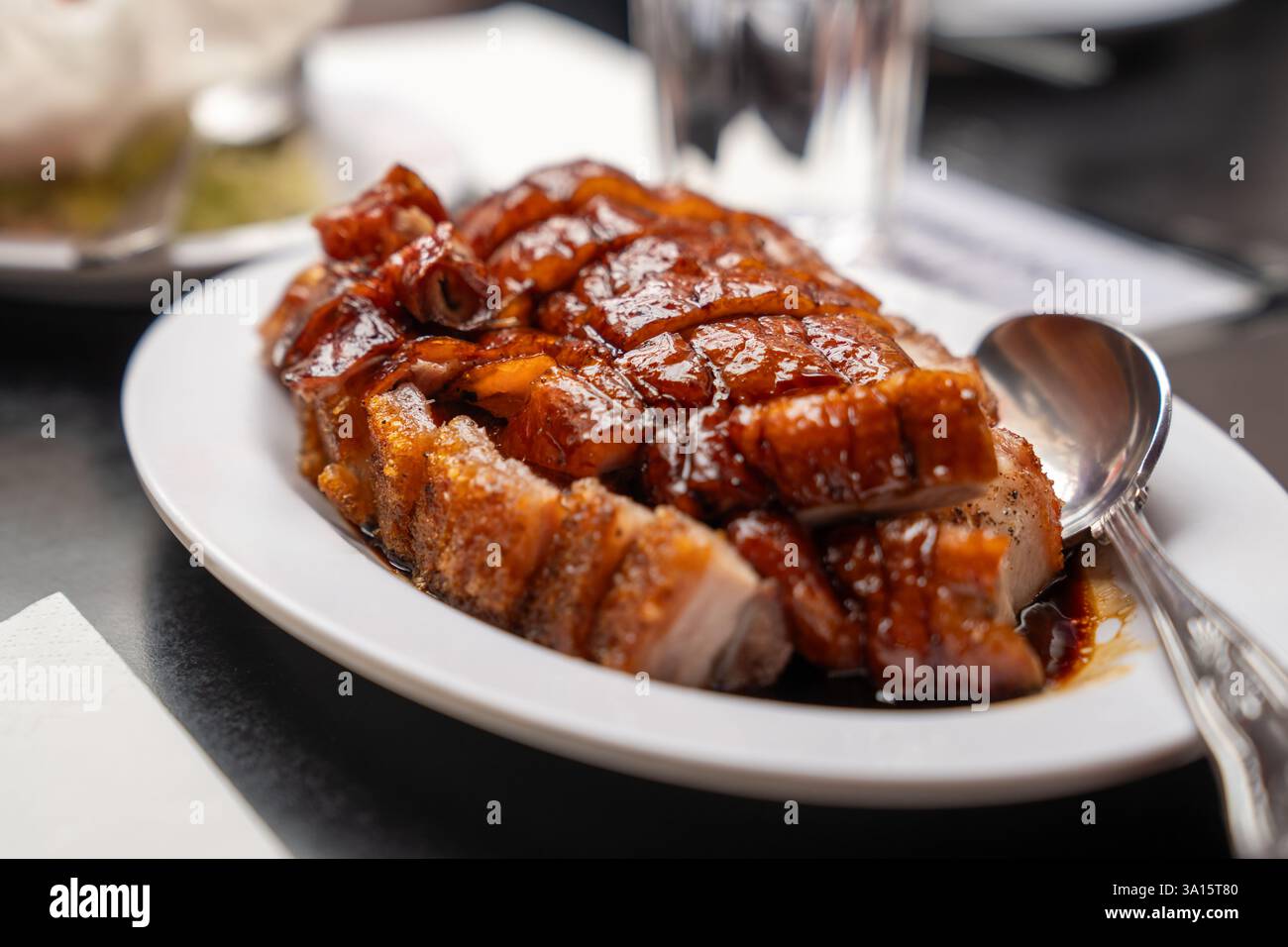 crispy pork and roasted duck is served with a caramelized glaze ...