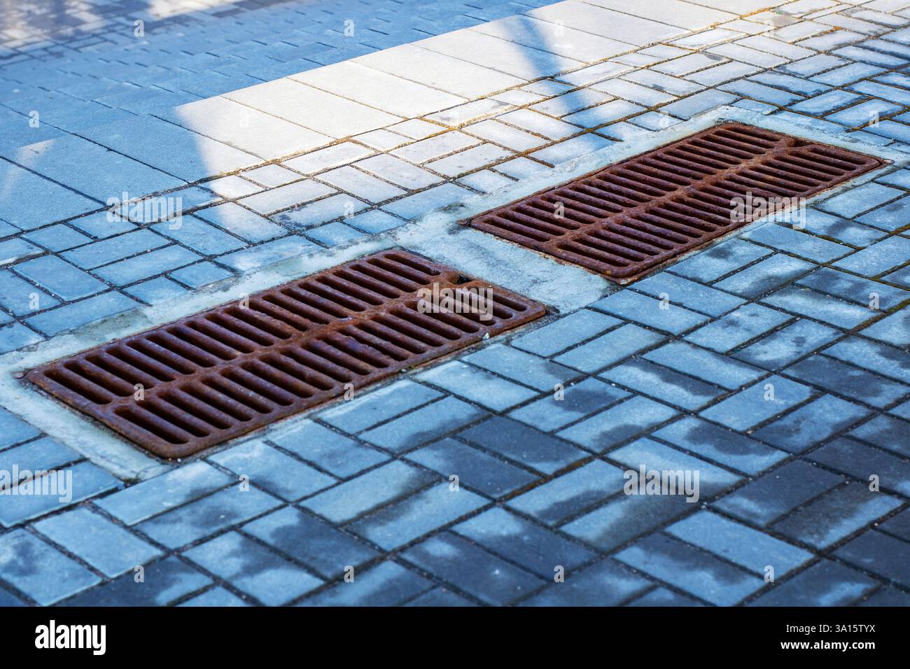 Two types of drains are positioned adjacent to one another on a sturdy ...