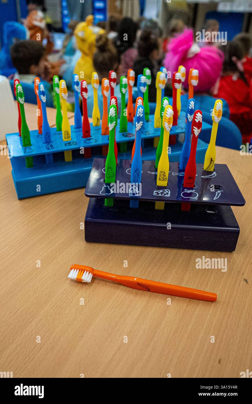 School children's toothbrushes in a stand inside a classroom at Fair ...