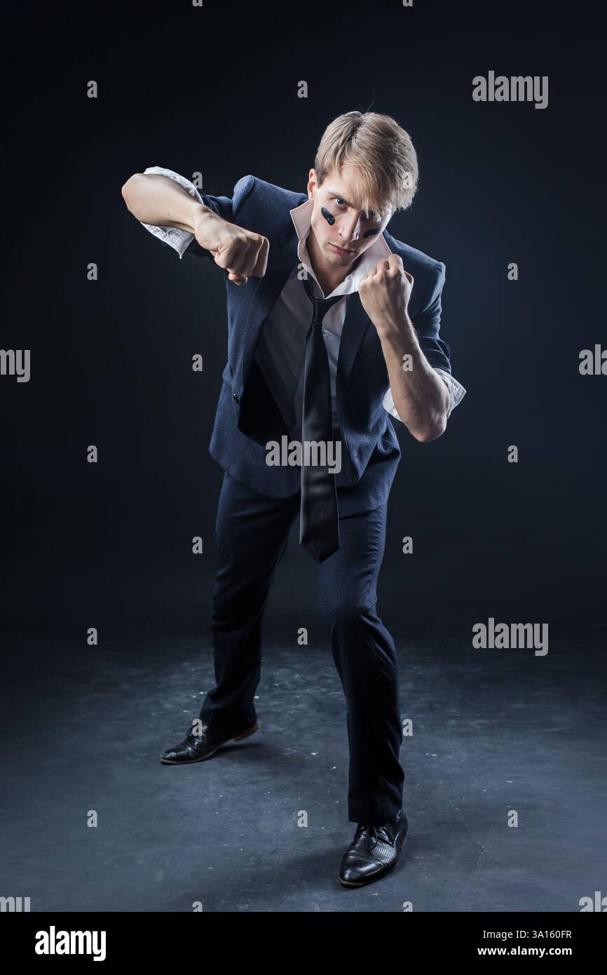 An aggressive businessman with war paint on his face is preparing for ...