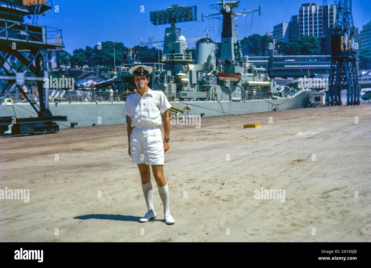 Naval officer standing in front of Leander Class frigate HMS Minerva ...