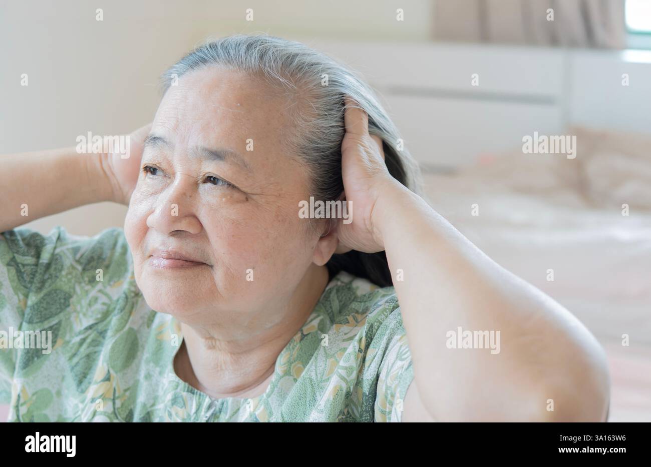 A senior woman suffers from a headache after wake up in the morning and ...