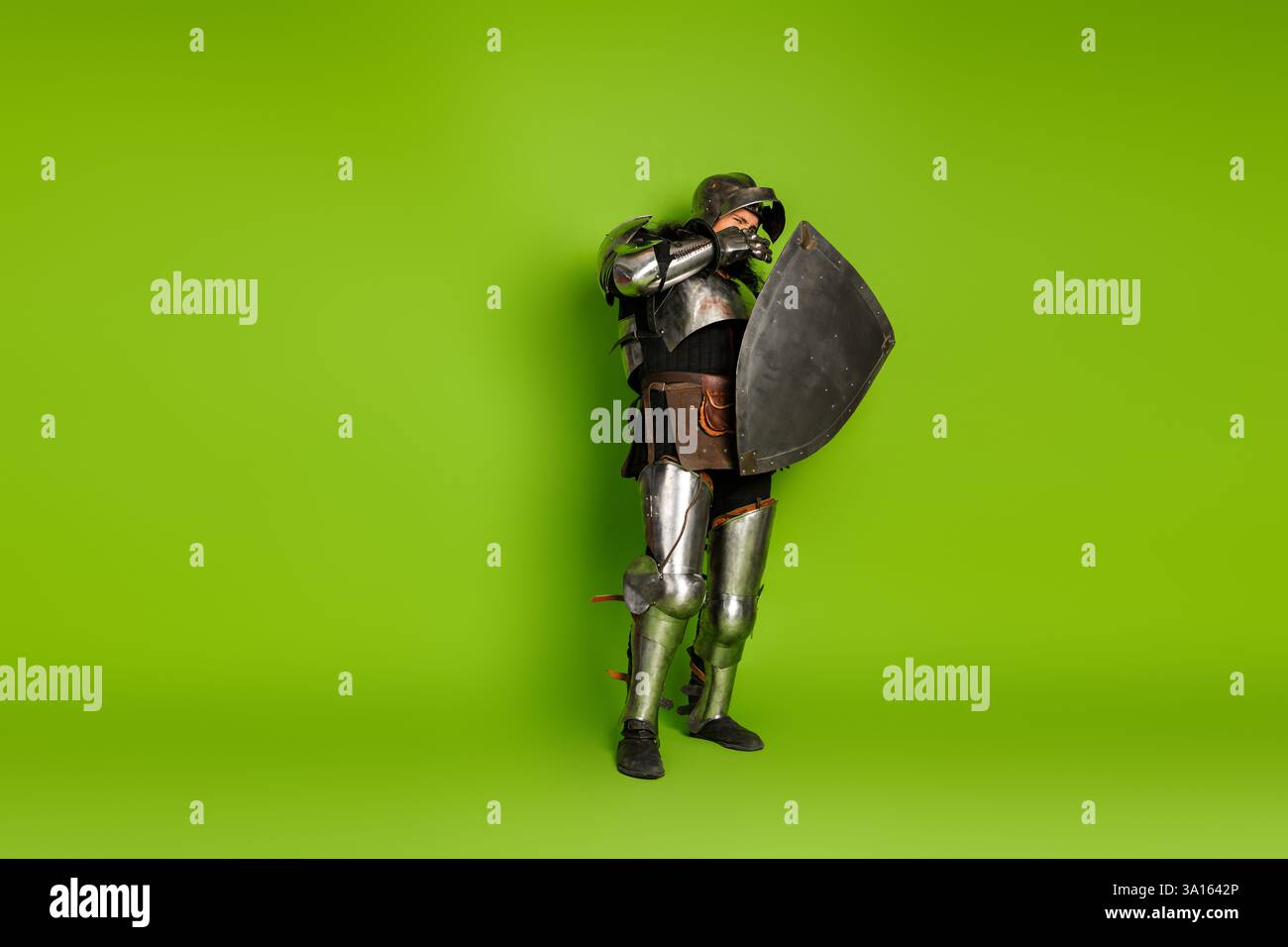 Medieval knight in full armor holding a shield, standing confidently ...