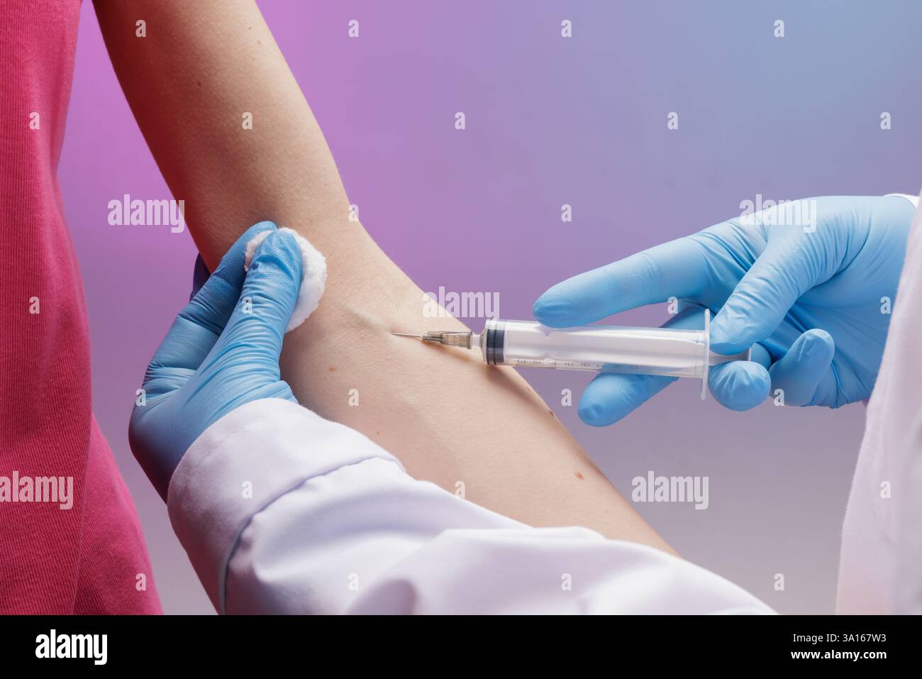Healthcare professional administering an injection in the patient's arm ...
