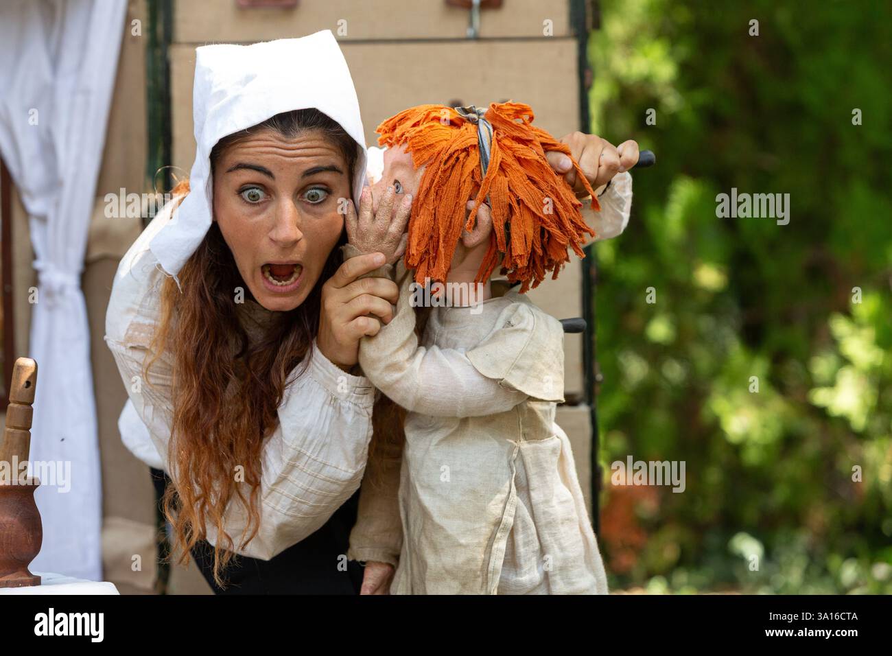 Puppeteer with surprised expression whispering to puppet during an ...