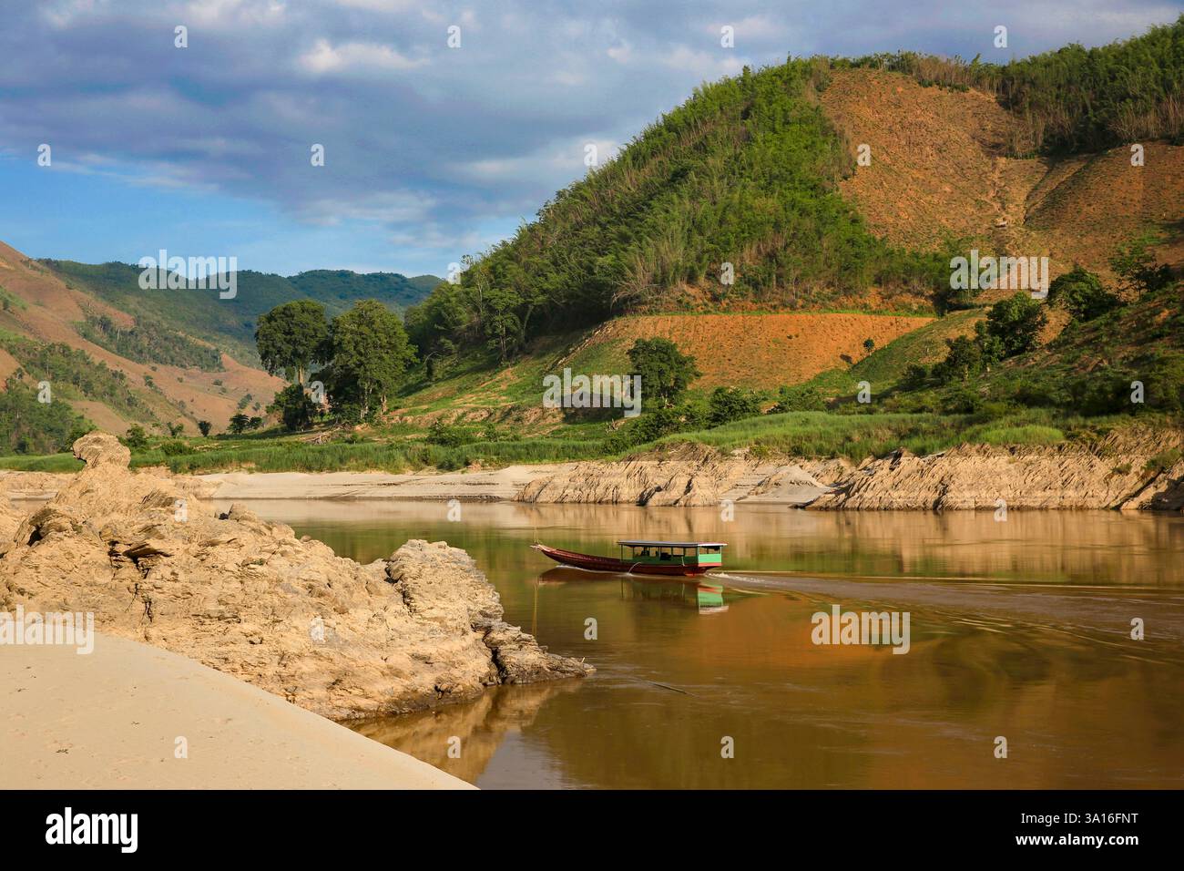 Laos, Mekong, Ban Baw, traditional rice barge on the brown river ...