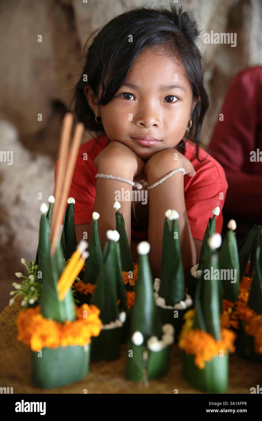 Laos, Mekong, Pak Ou caves, girl selling banana leat offerings in the ...