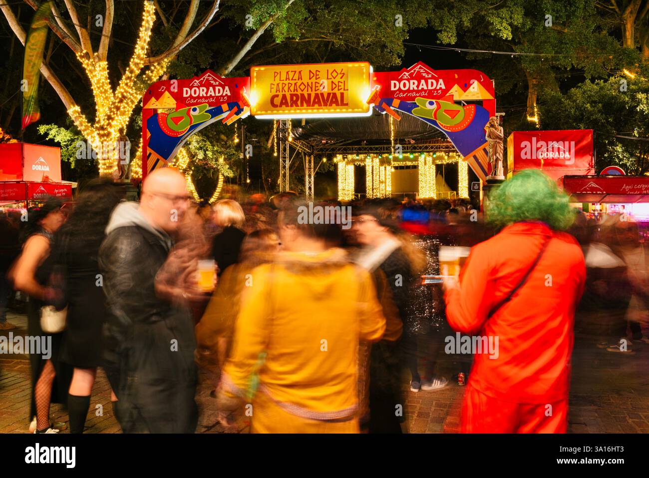 Live music performance stage with crowds of costumed attendees drinking ...