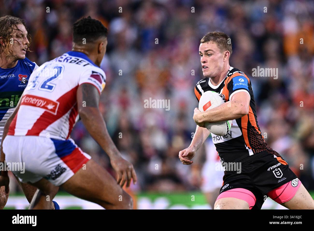 Lachlan Galvin of the Tigers runs the ball during the NRL Round 1 match ...